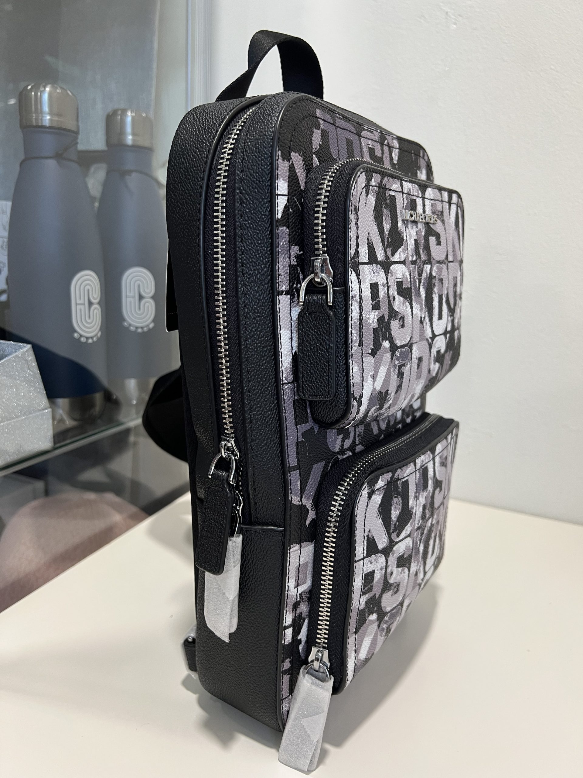 Michael Kors Cooper Utility Slingpack in Signature Black – Exclusively USA